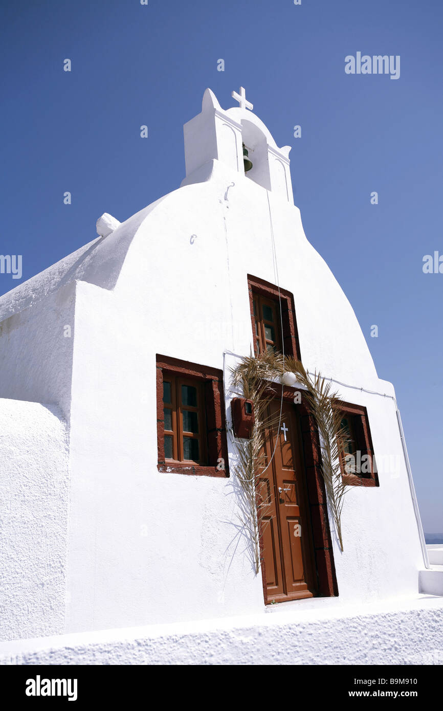 An orthodox greek chapel,in Oia on Santorini,against a bright blue sky ...