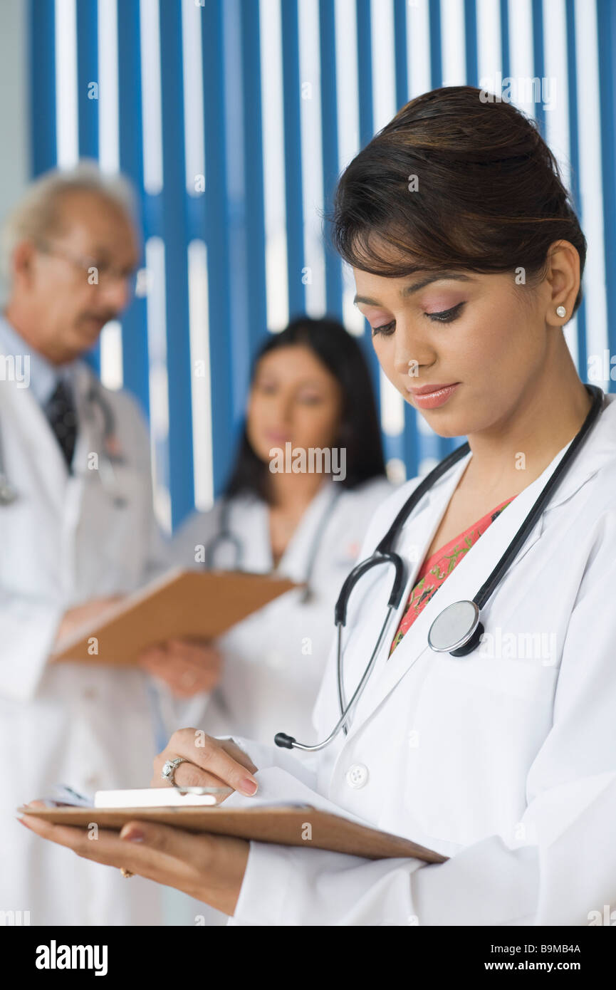 Doctors examining a report Stock Photo - Alamy