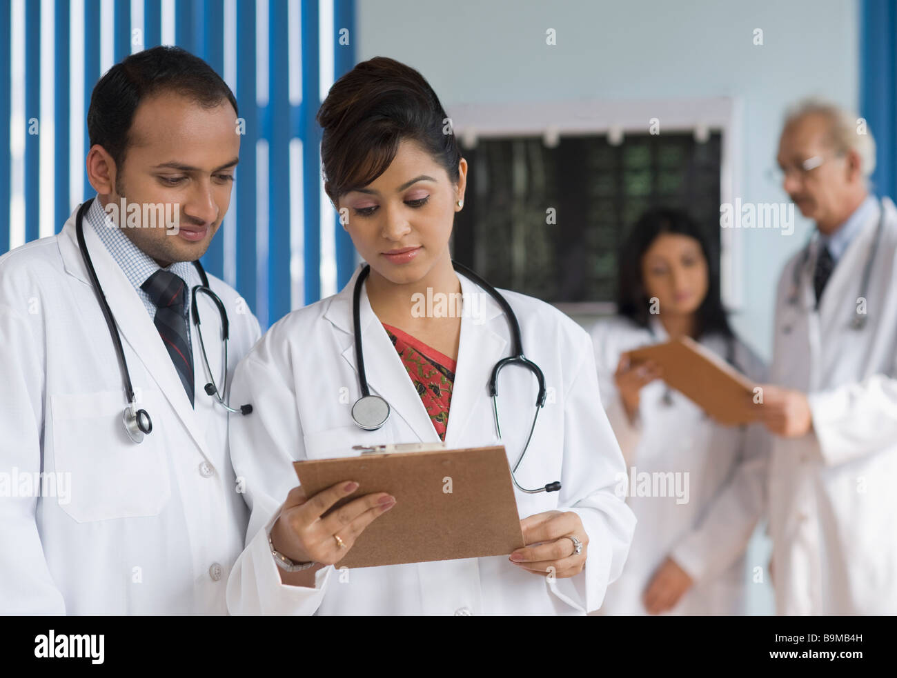 Doctors examining reports Stock Photo - Alamy