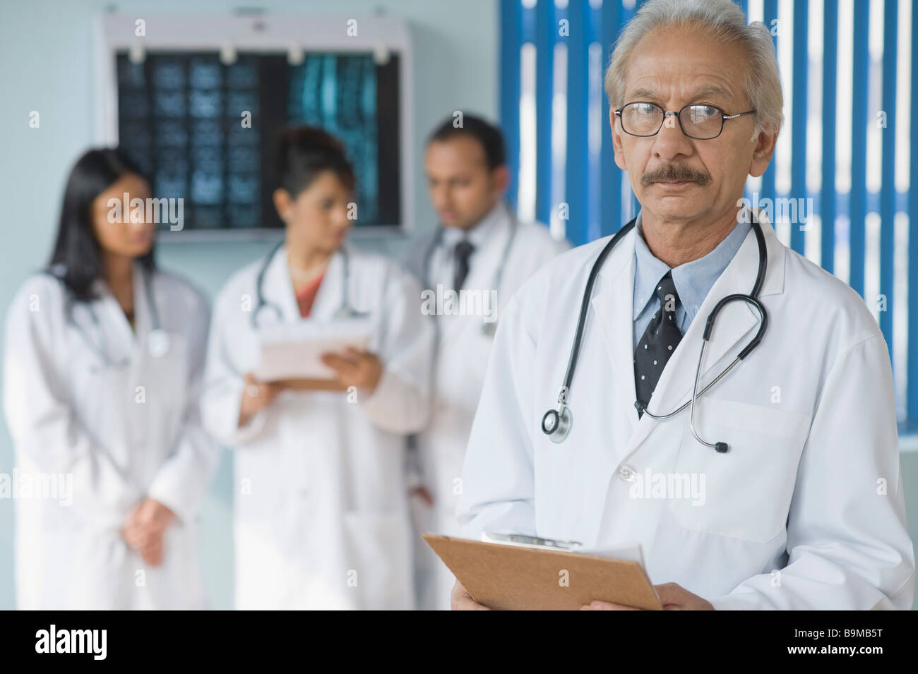 Doctor holding a report Stock Photo - Alamy