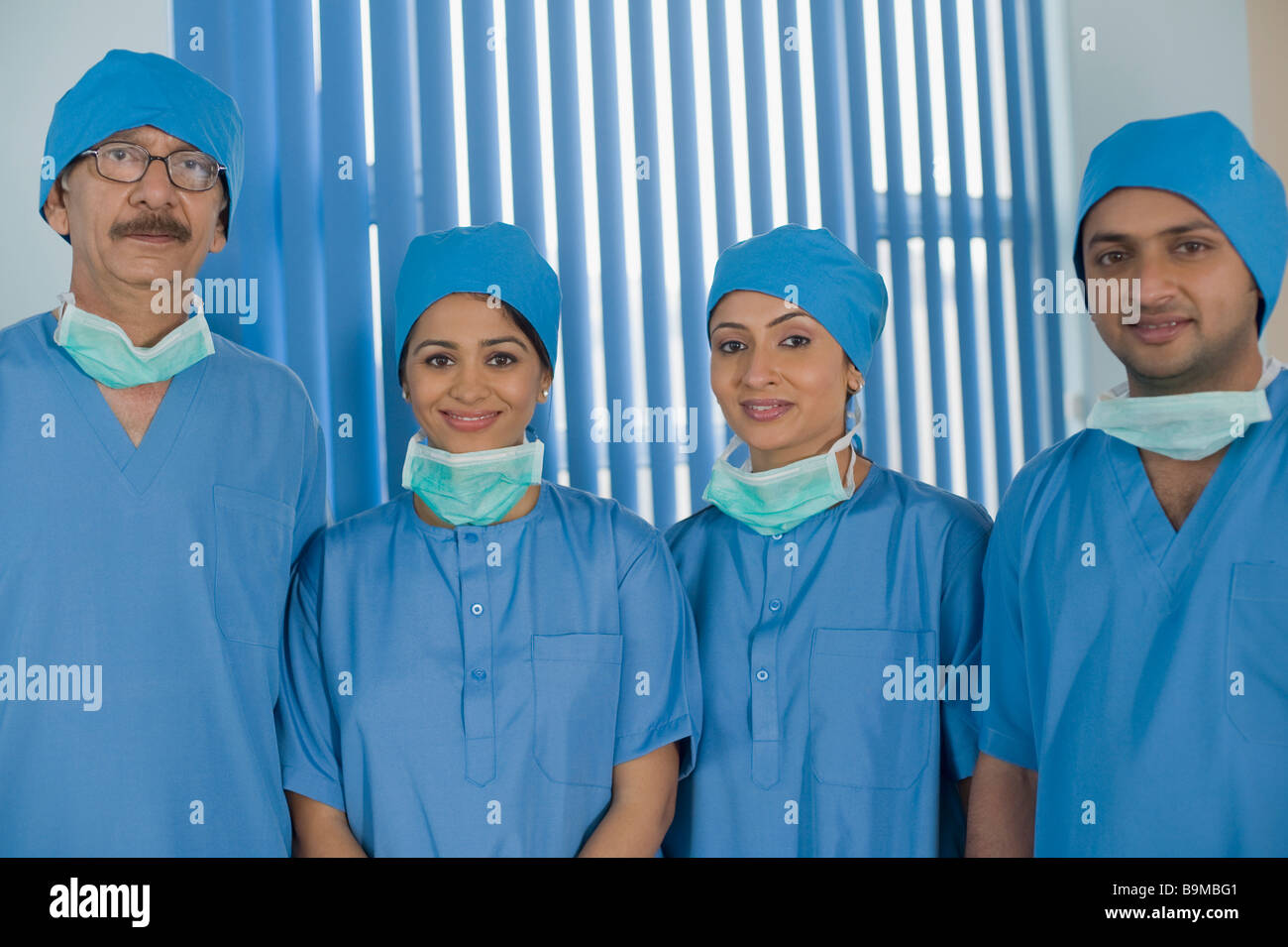 Portrait of four doctors smiling Stock Photo - Alamy