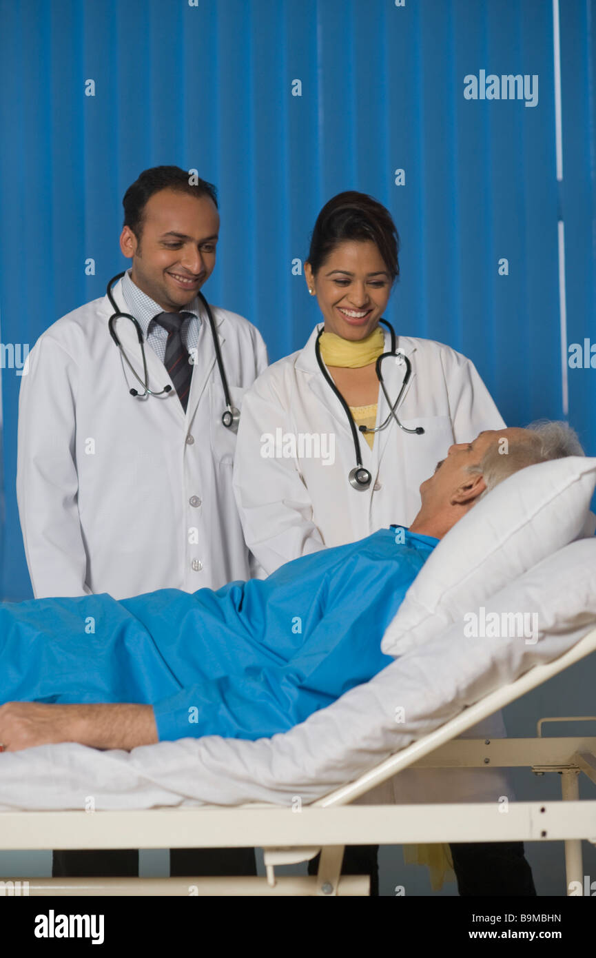 Doctors discussing with a patient Stock Photo - Alamy