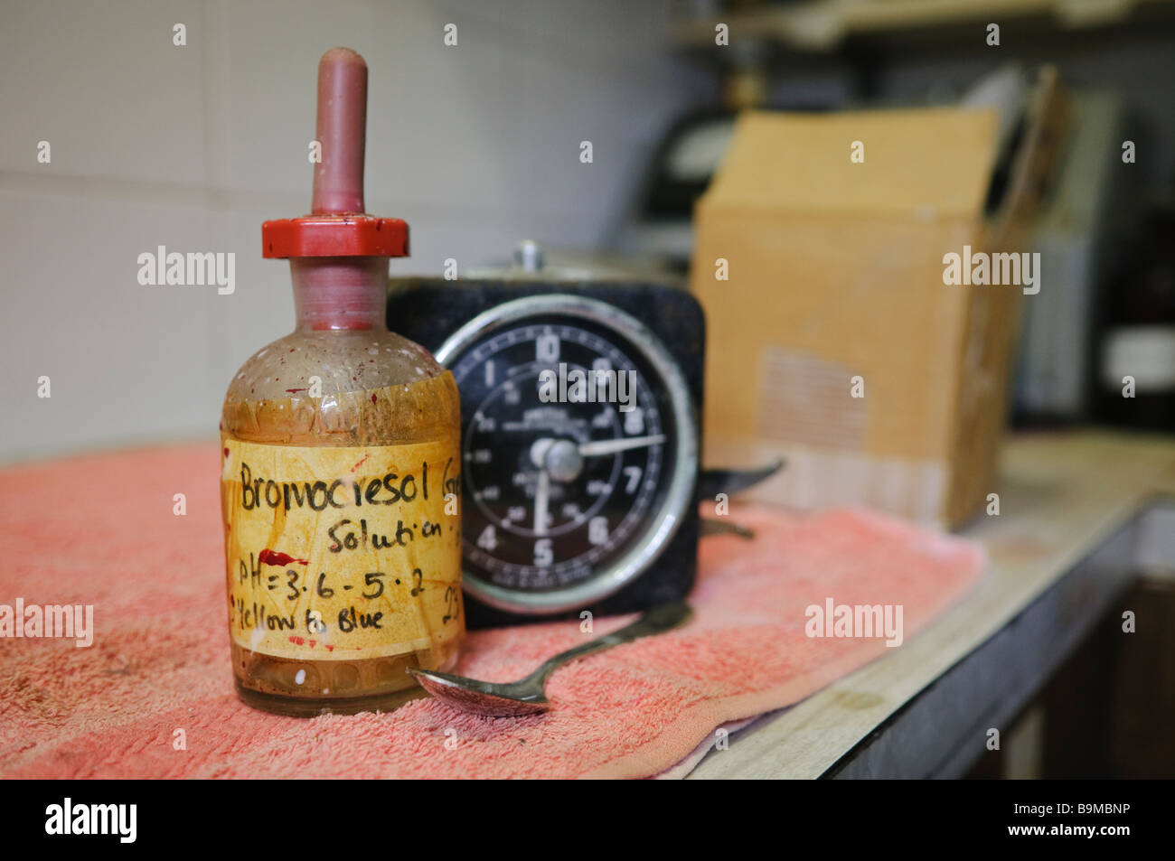 Old laboratory stopwatch/timer with a dropper bottle labelled ...