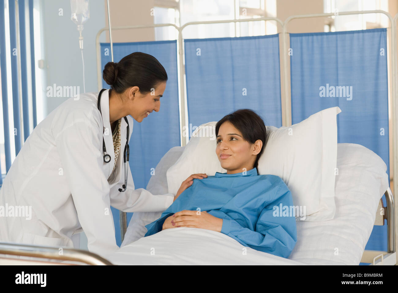 Female doctor talking with a patient Stock Photo - Alamy