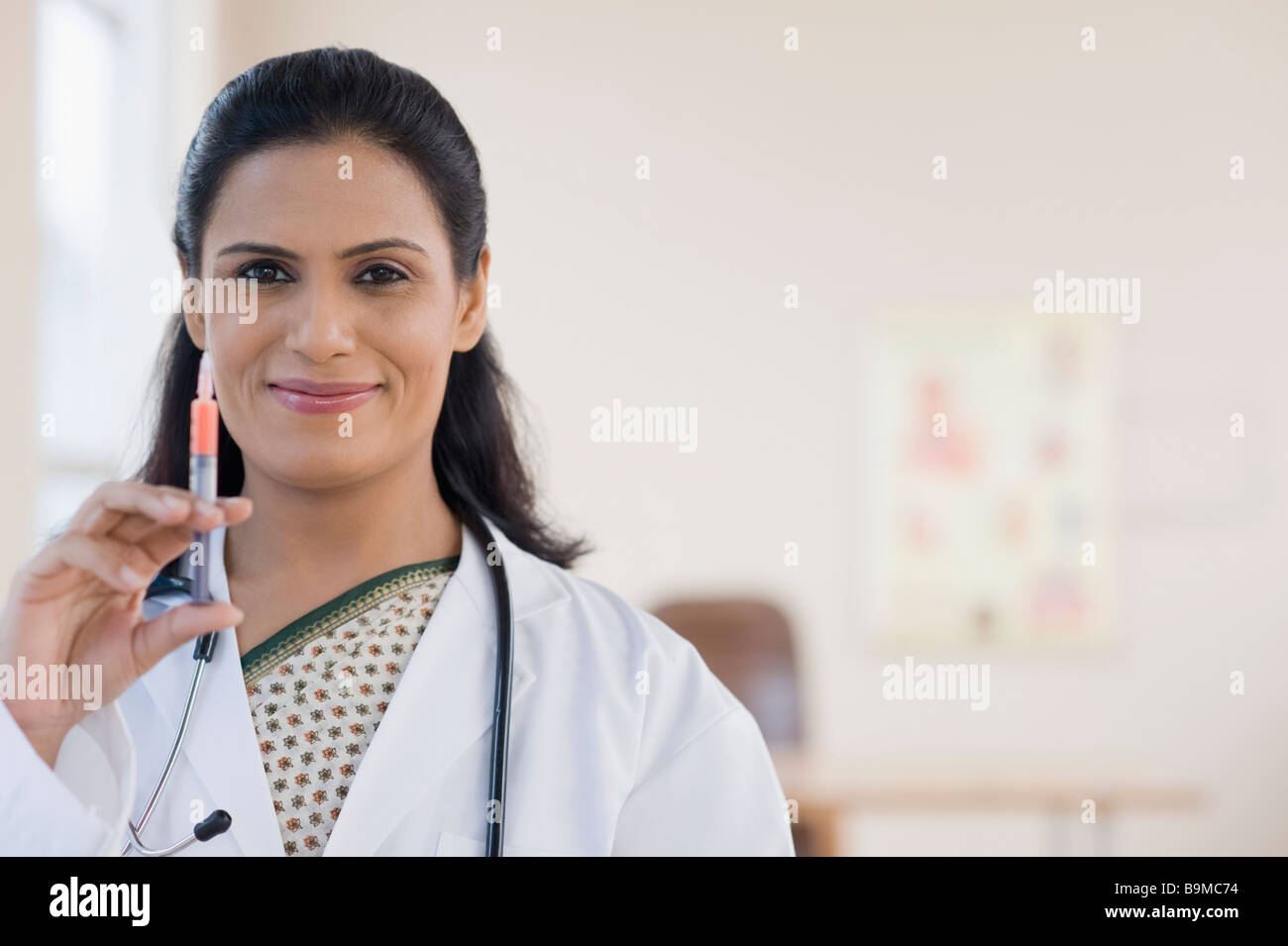 Female doctor holding an injection Stock Photo - Alamy