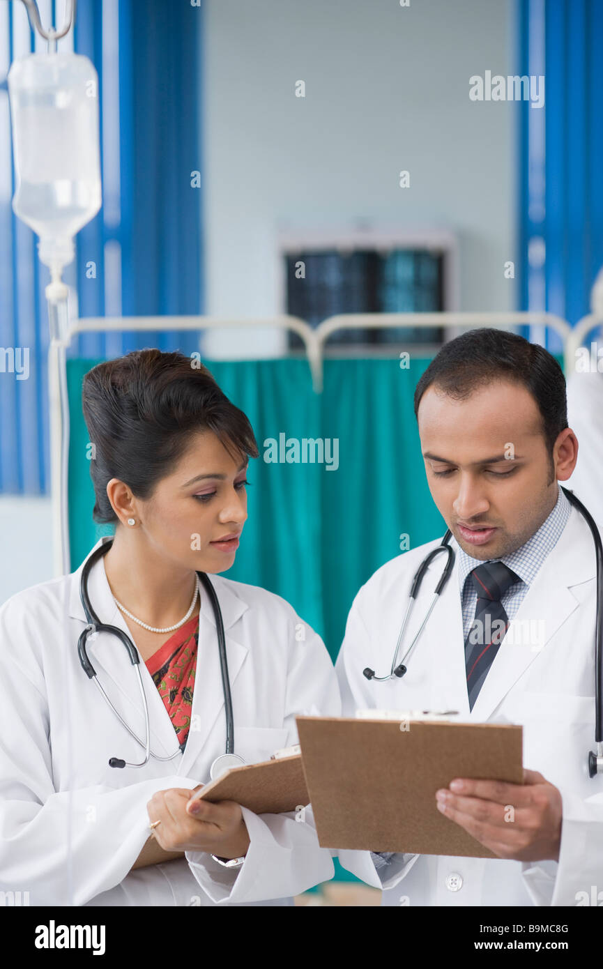 Two doctors discussing a report Stock Photo - Alamy