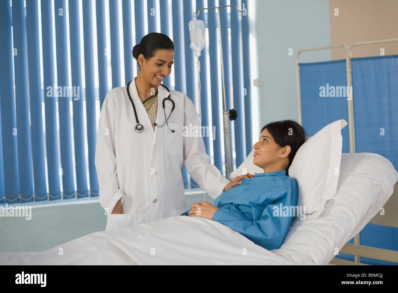 Female doctor talking with a patient Stock Photo - Alamy