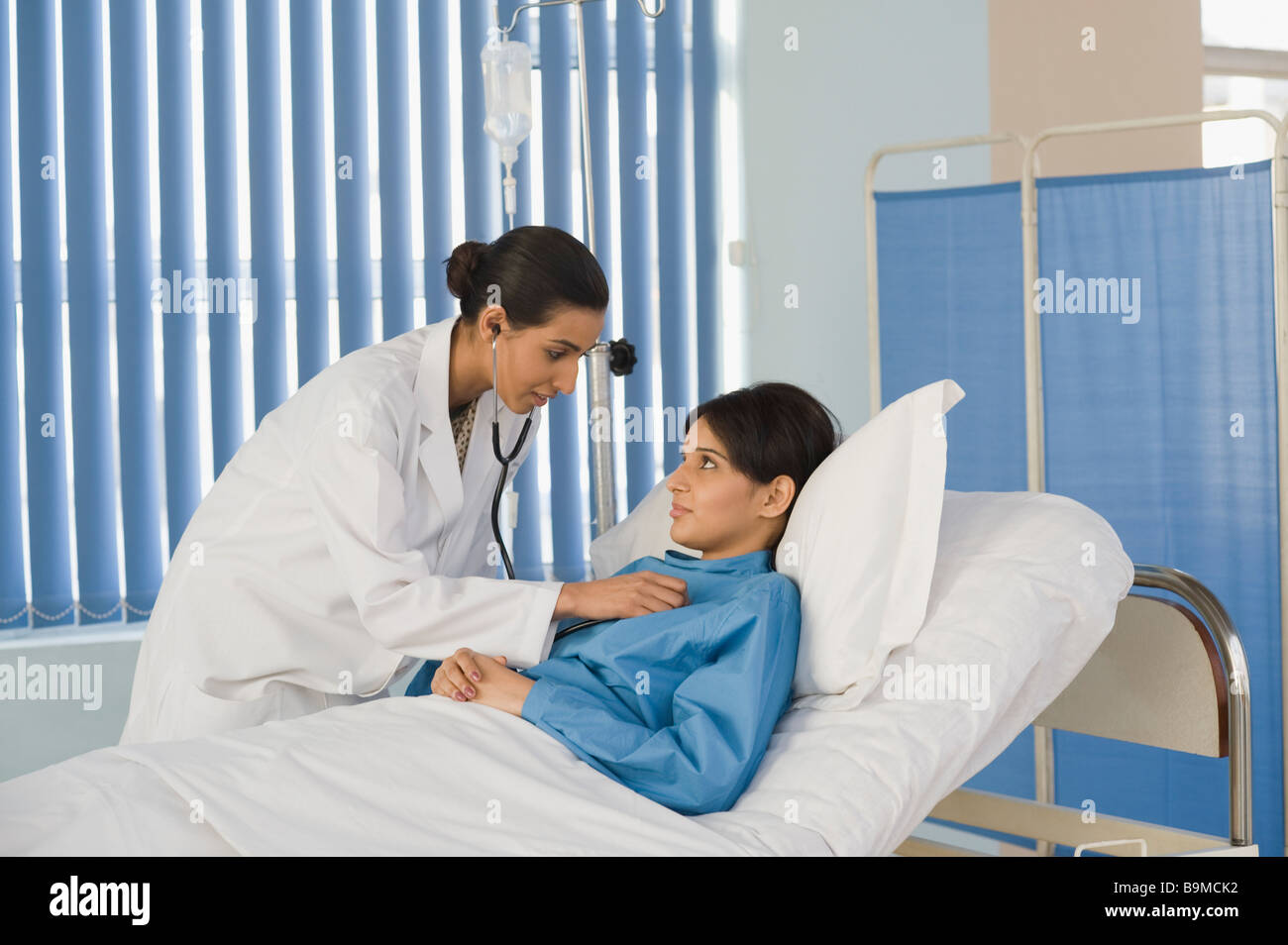 Female doctor examining a patient Stock Photo - Alamy