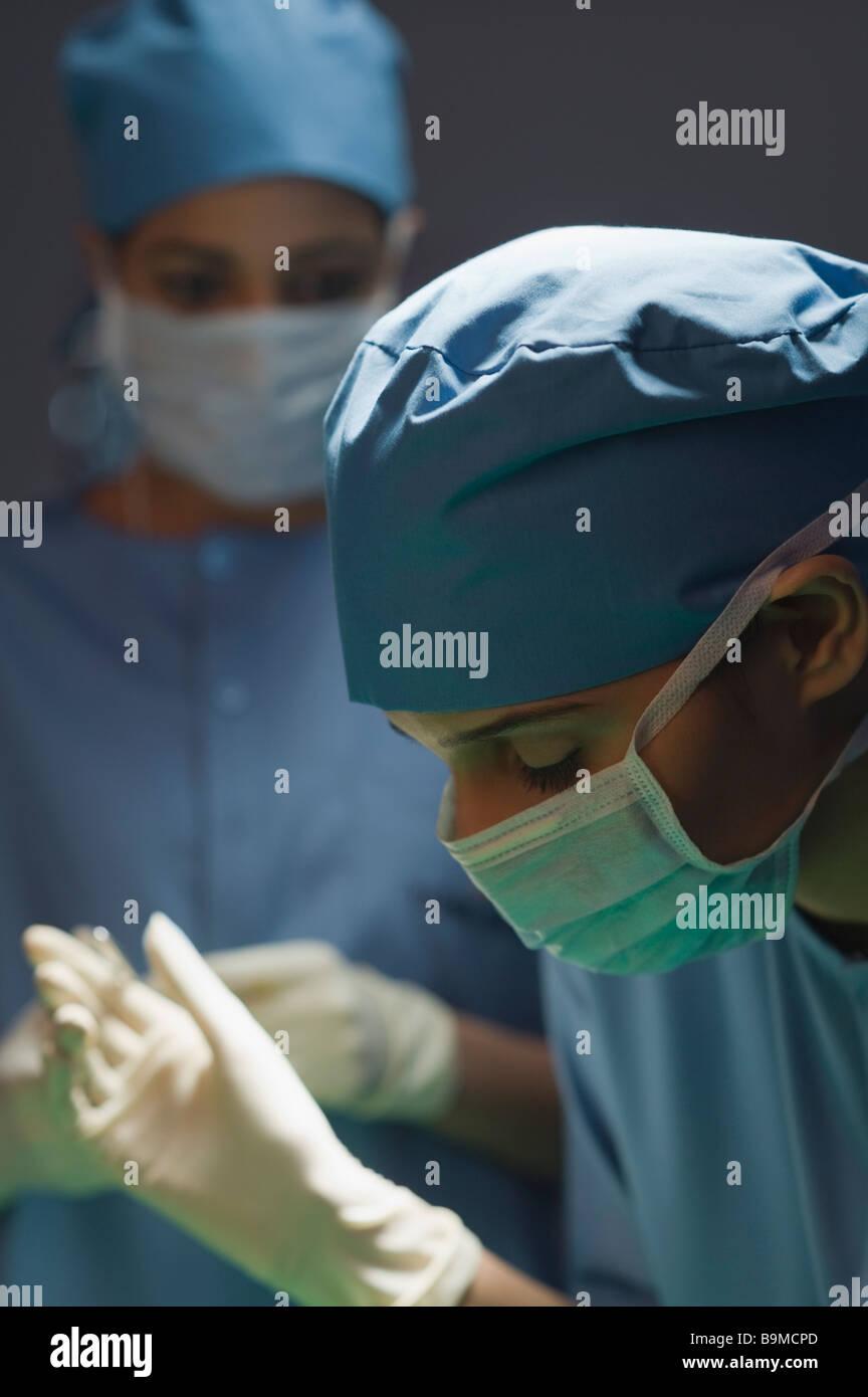 Two female surgeons performing a surgery in an operating room Stock ...