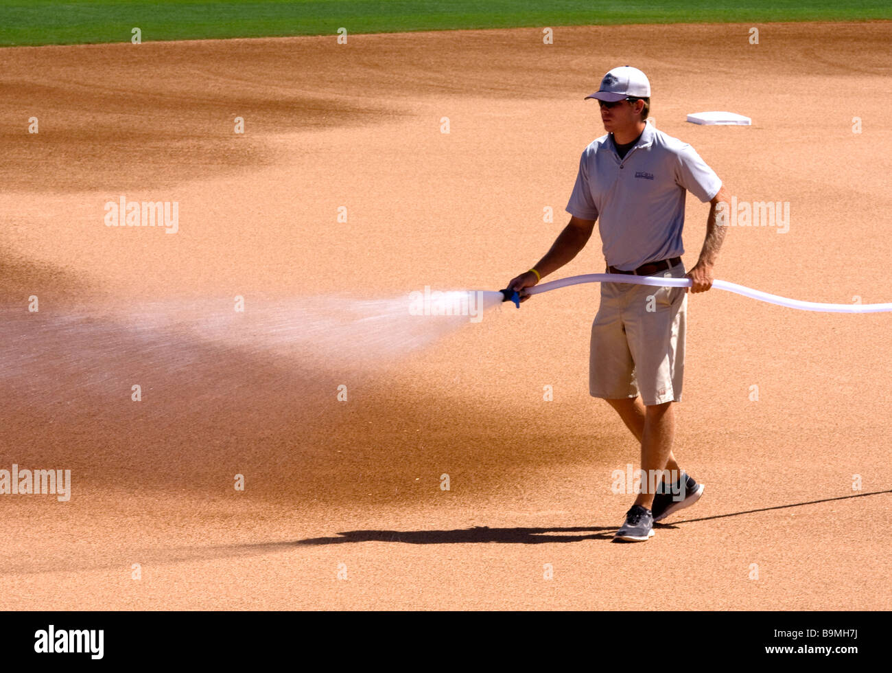 A member of the grounds crew at Peoria Sports Complex in Arizona ...