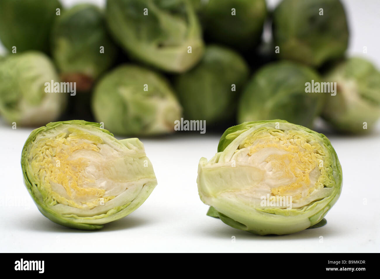 A sliced brussels sprout,macro view,in front of a pile of other sprouts ...