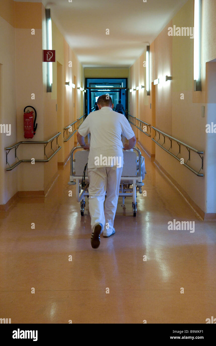 Man pushing a bed with a patient, Berlin, Germany Stock Photo - Alamy