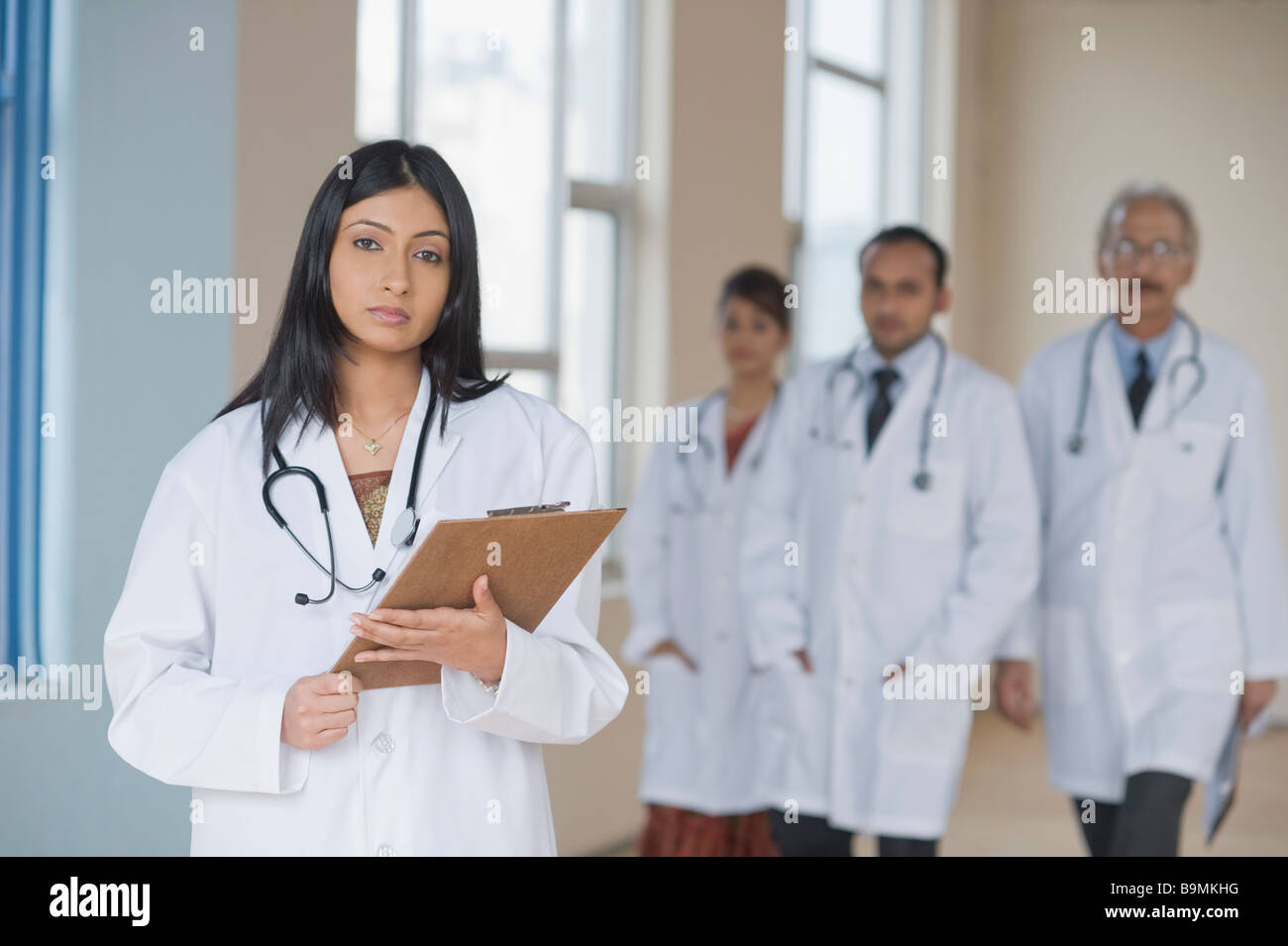 Four doctors standing in a hospital Stock Photo - Alamy