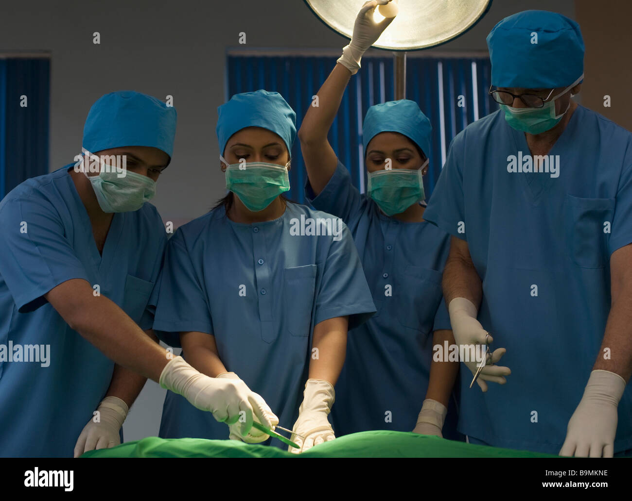 Surgeons performing a surgery in an operating room Stock Photo - Alamy