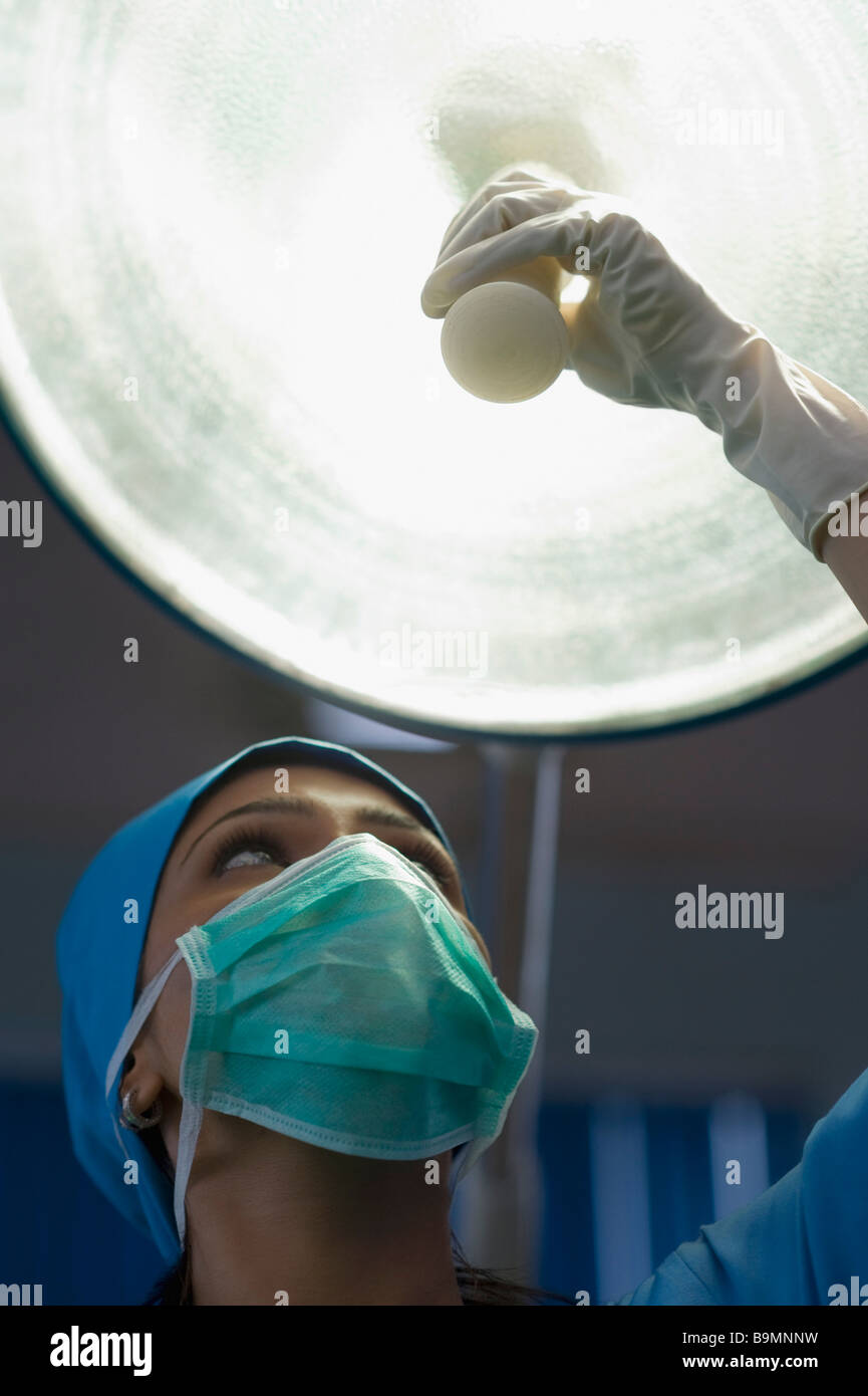 Female surgeon adjusting a surgical lamp Stock Photo - Alamy