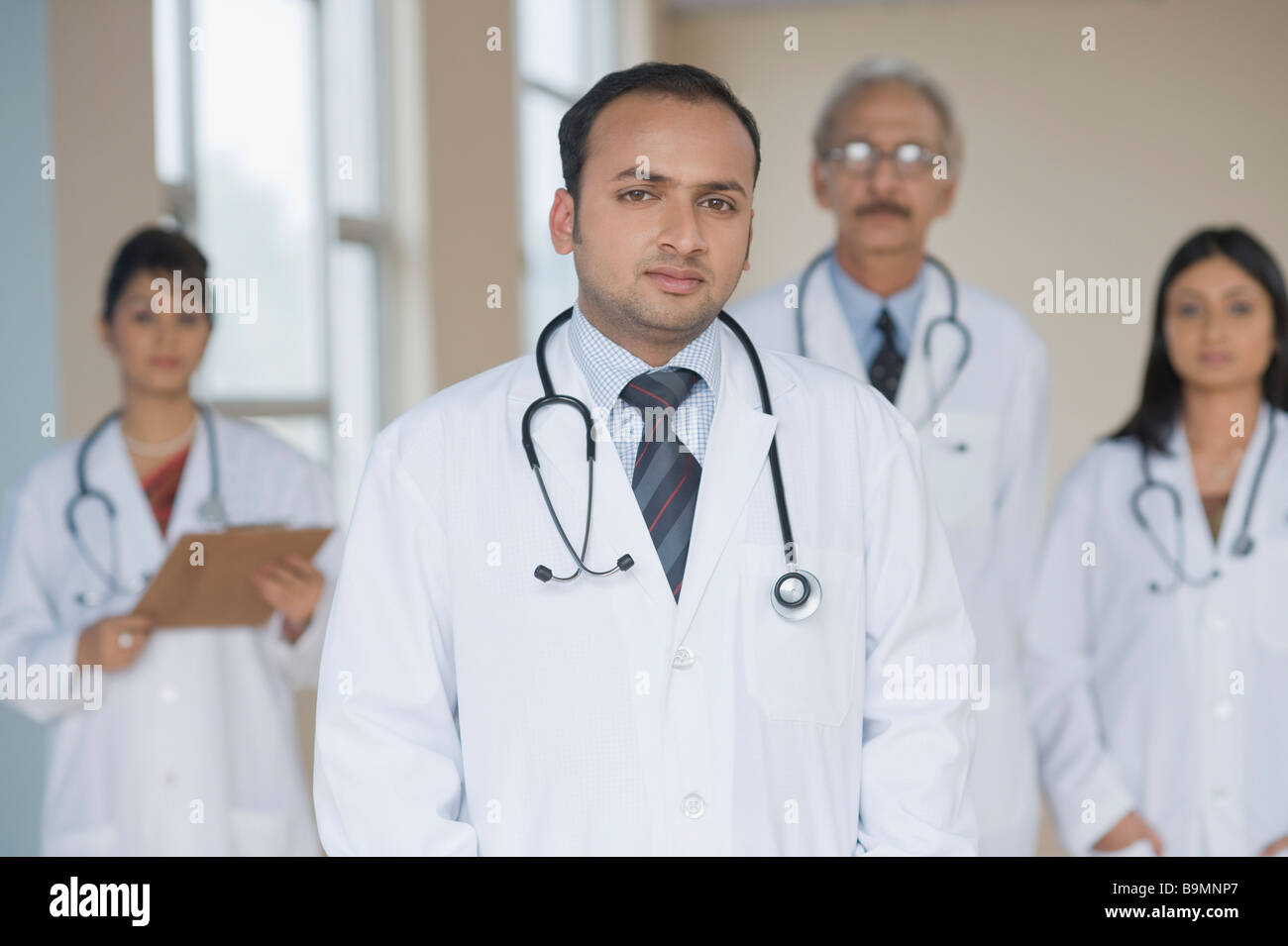 Four doctors standing in a hospital Stock Photo - Alamy