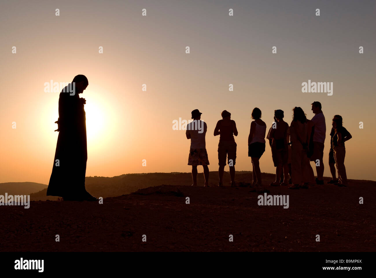 Jordan, Tafilah Governorate, tourists and Bedouin on roadside at sunset ...