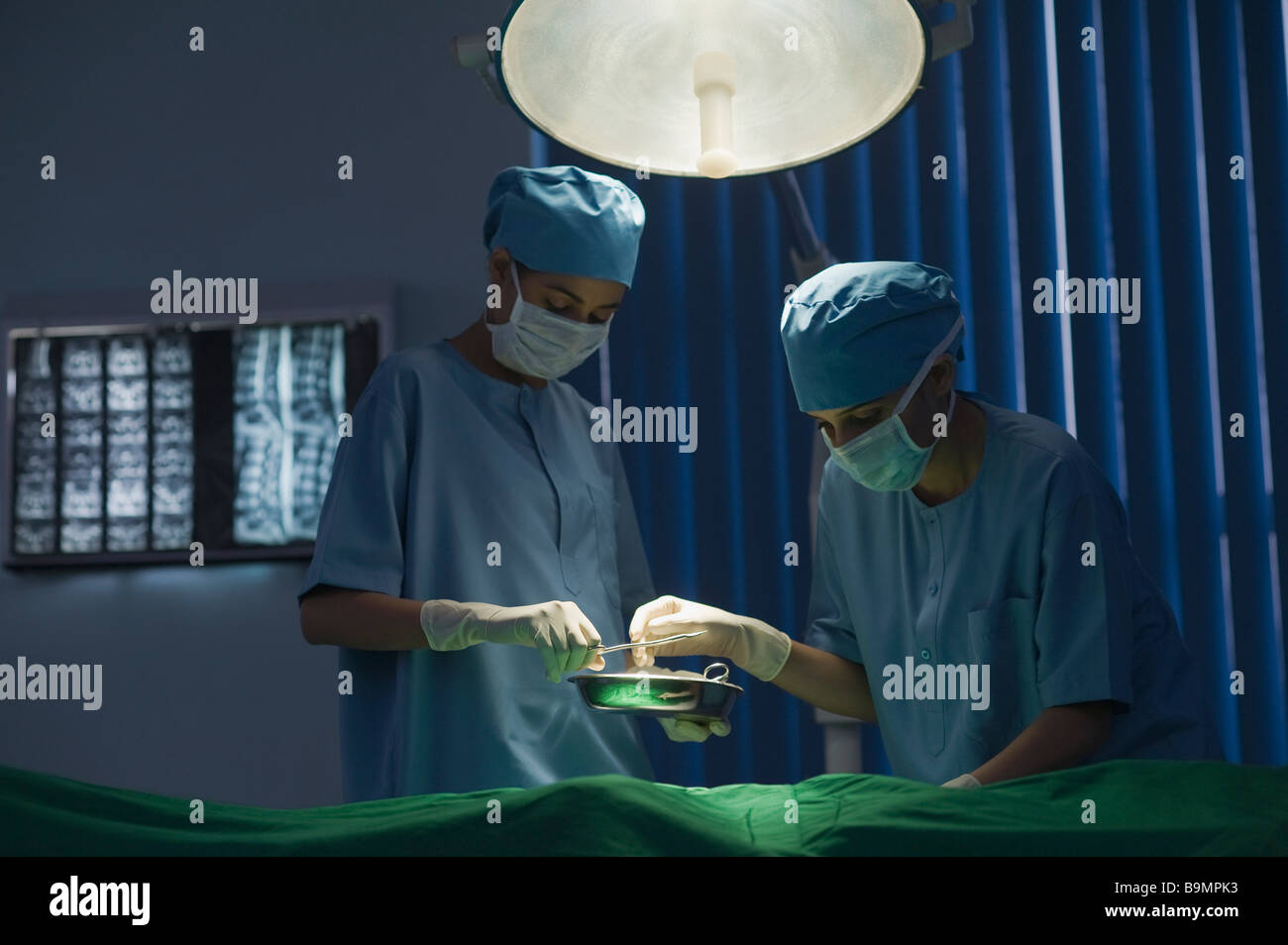 Two female surgeons performing a surgery in an operating room Stock ...