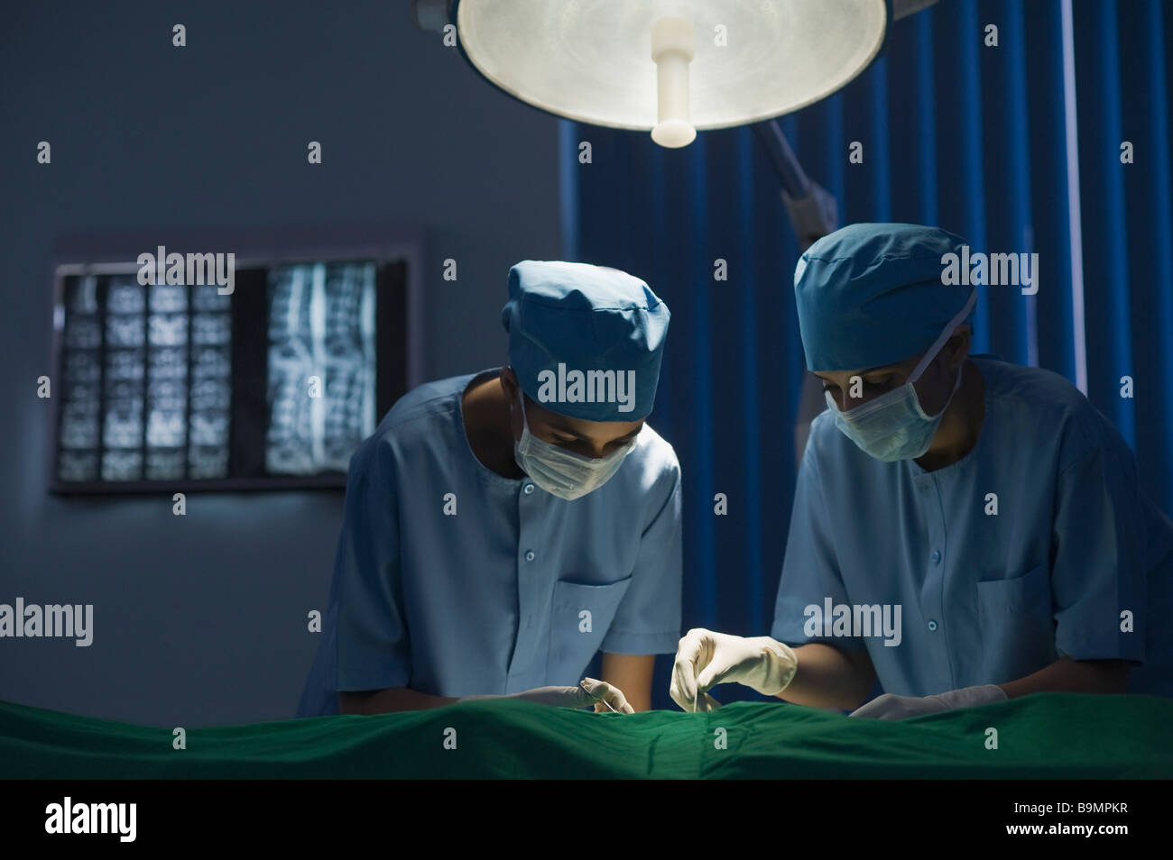 Two female surgeons performing a surgery in an operating room Stock ...