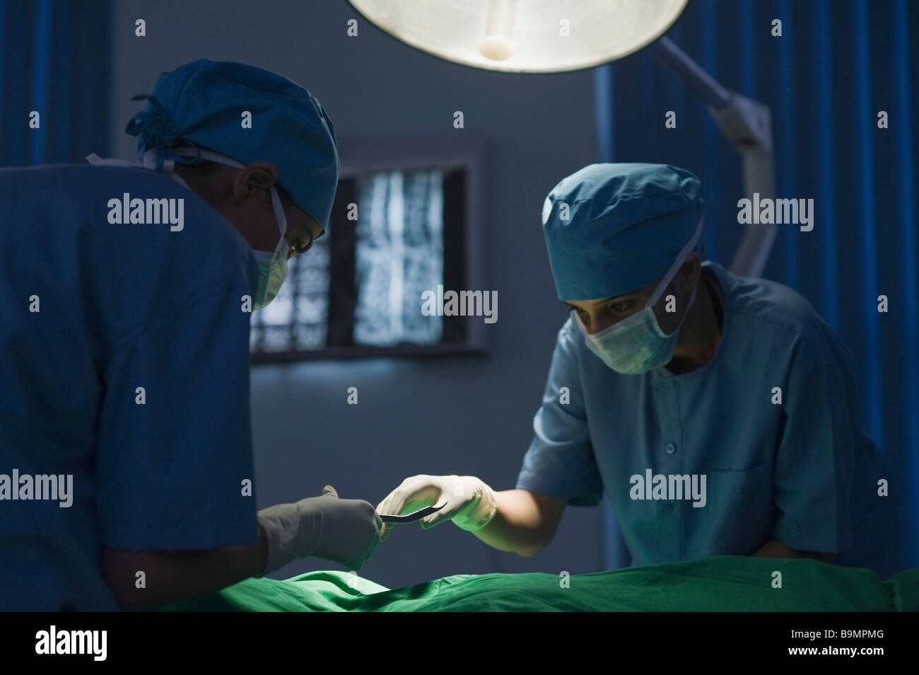 Two female surgeons performing a surgery in an operating room Stock ... Two female surgeons performing a surgery in an operating room Stock ...