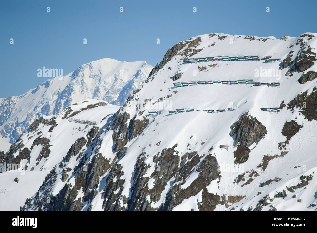 avalanche protection barriers on alpine mountainside with Mont Blanc ...
