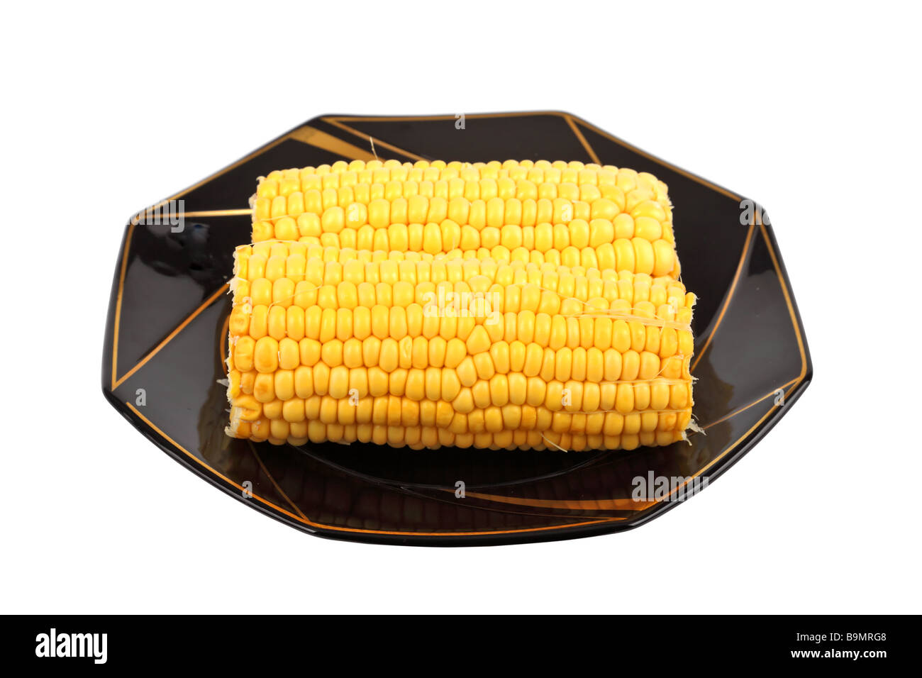 Corn on the cob on a black plate Stock Photo - Alamy