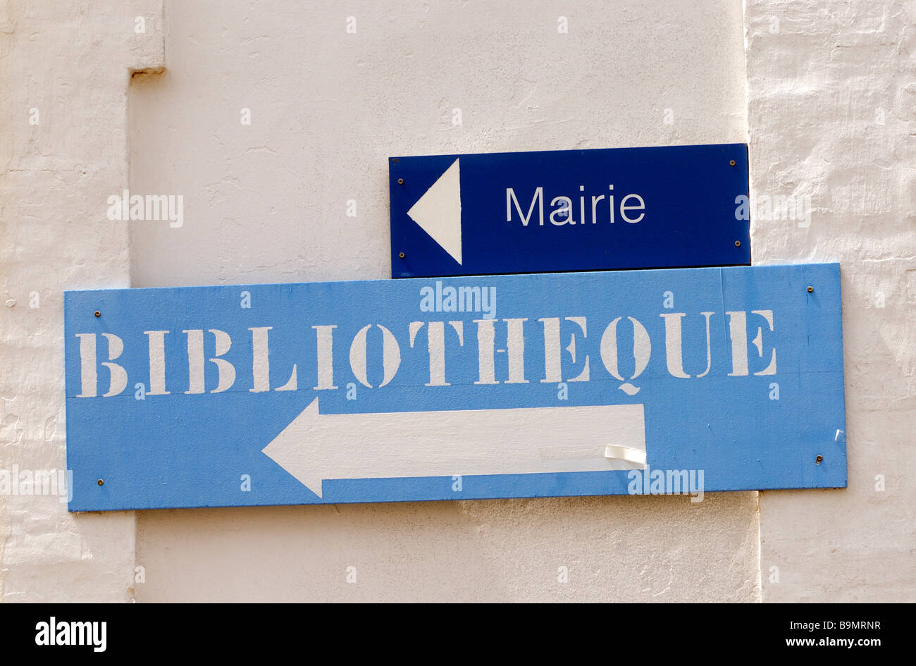 Blue signs with white arrows point the bibliotheque library and Mairie ...
