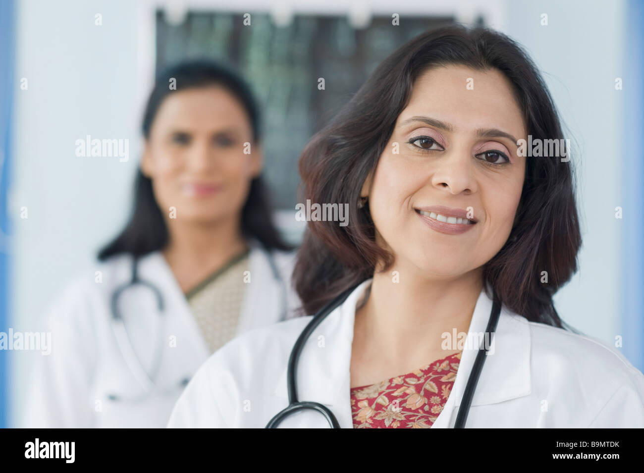Portrait of a female doctor smiling Stock Photo - Alamy