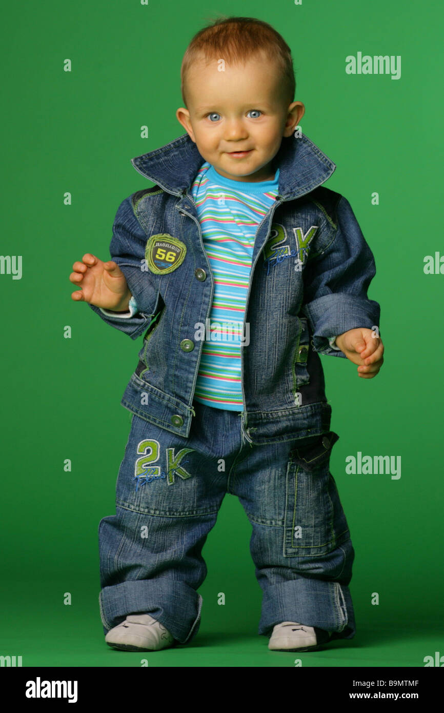 Ten month old baby in the studio on green background Stock Photo - Alamy