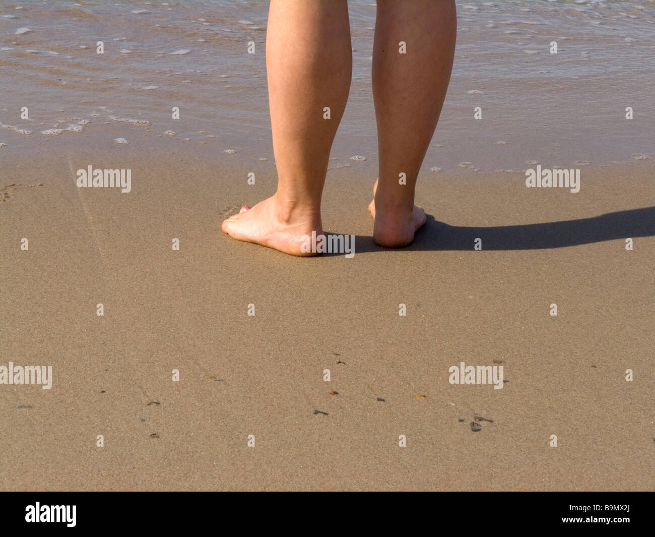 Enjoing warm summer waters of the northsea with bare feet on the sand ...