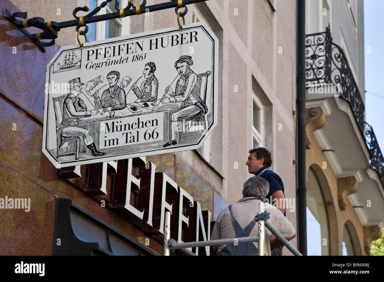 Shop sign and workers Munich Germany Stock Photo - Alamy
