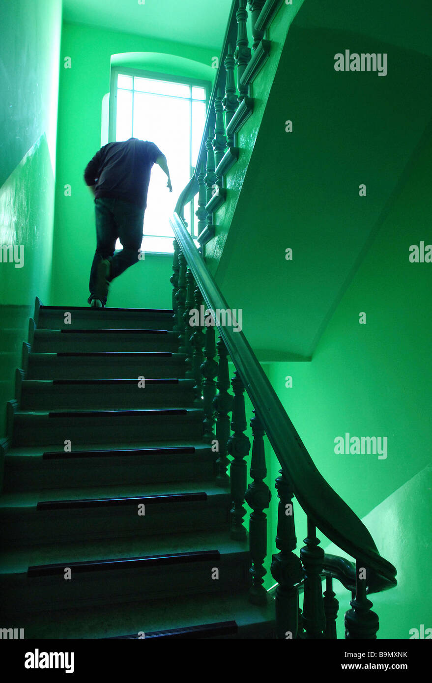 Man running upstairs Stock Photo - Alamy