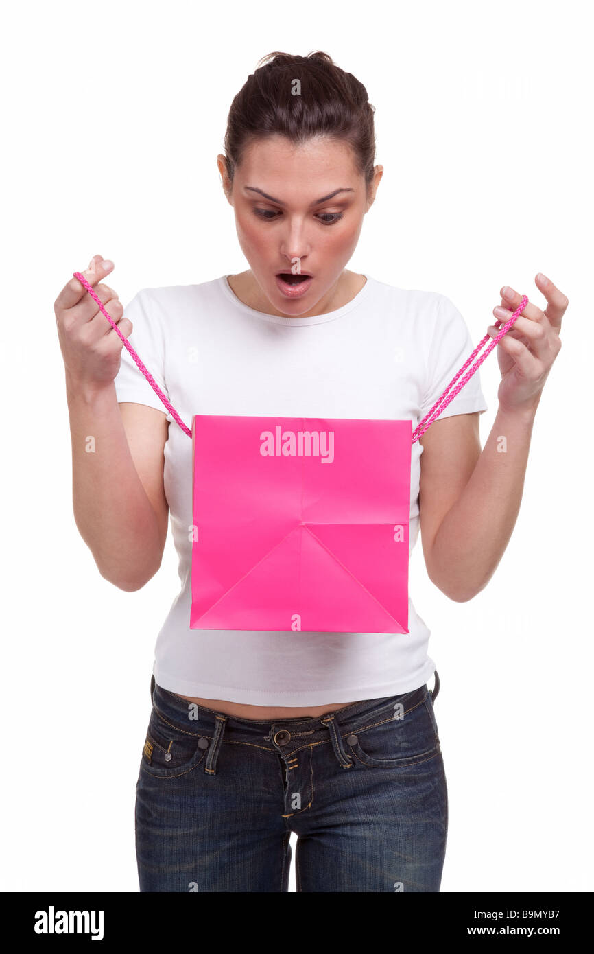 Attractive young female opening a gift bag with a surprised expression ...
