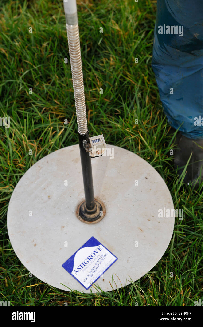 Farmer with a Plate Measurer which measures the depth of grass of a ...