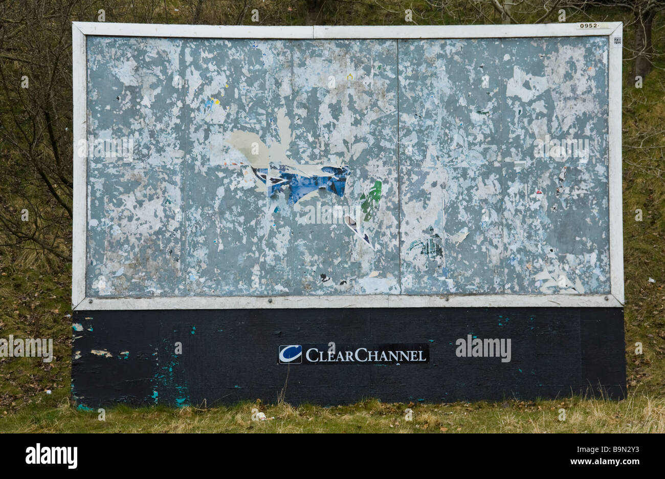 Empty and tattered ClearChannel advertising billboard on waste ground ...