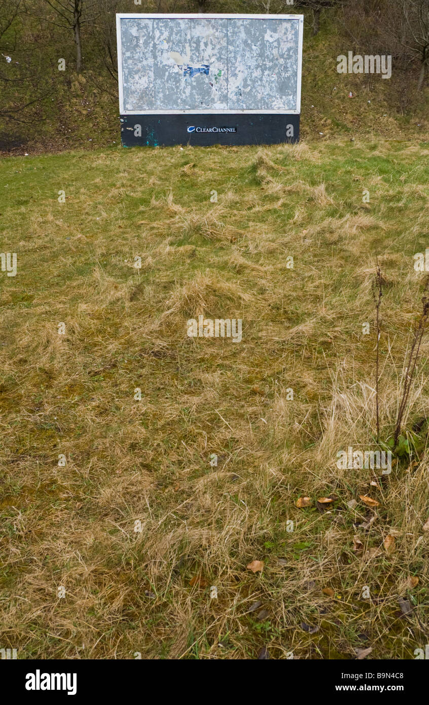 Empty and tattered ClearChannel advertising billboard on waste ground ...