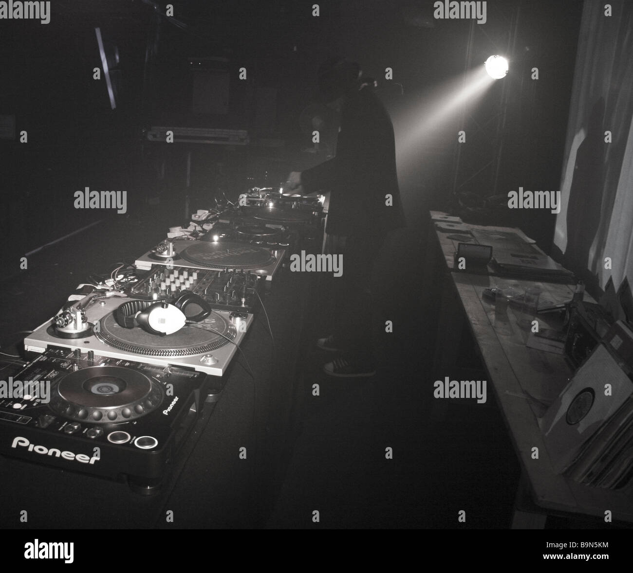 Moody shot of a DJ playing in a dark night club, black and white Stock ...