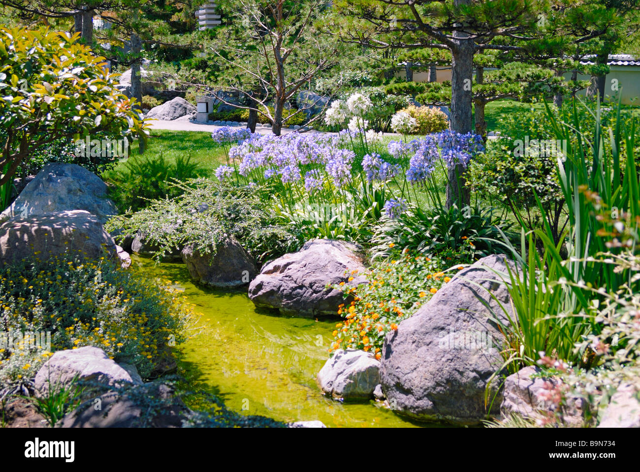 Beautiful garden with stream Stock Photo - Alamy