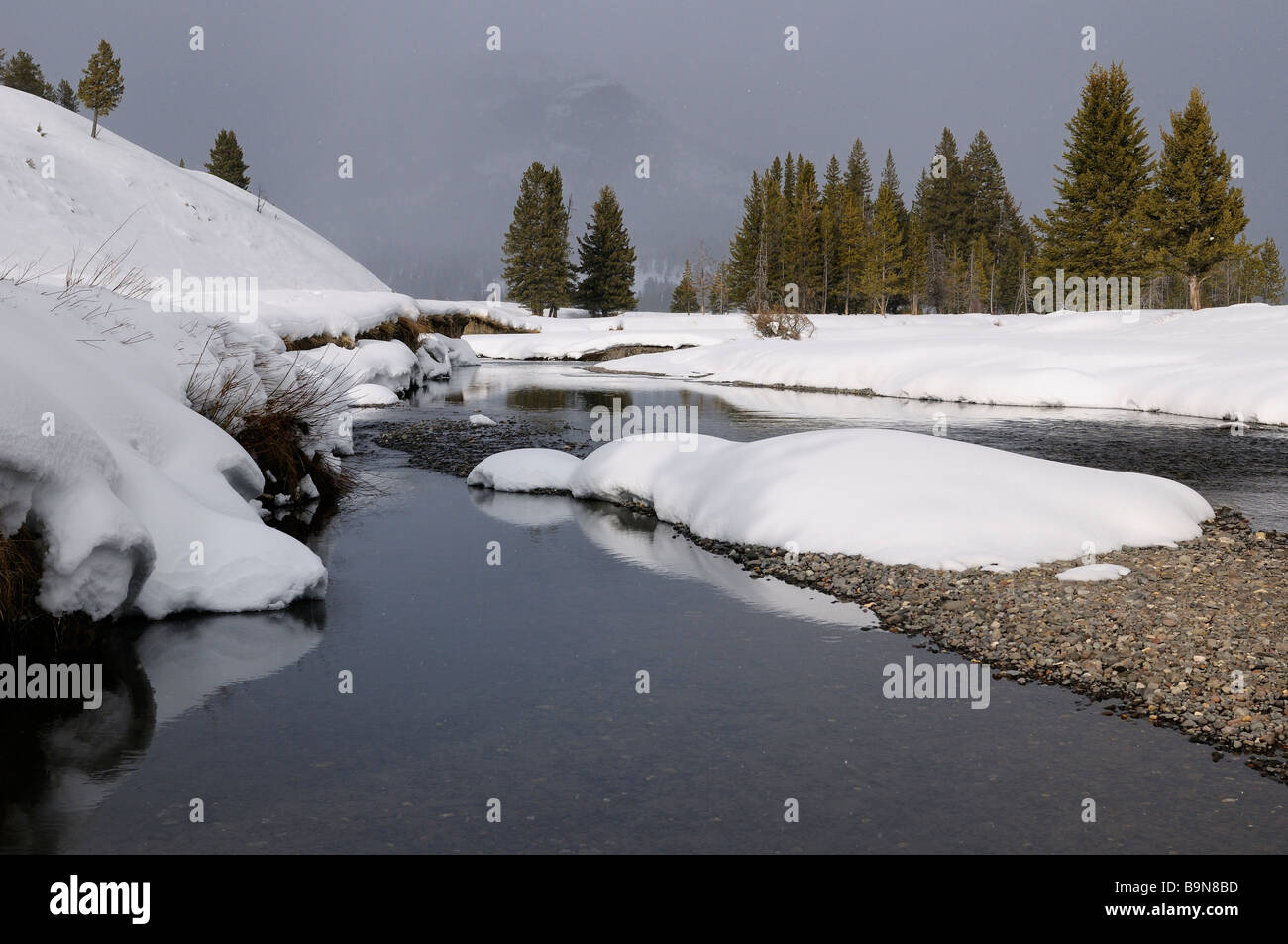 Soda Butte Creek during a snowfall in winter with Abiathar Peak in ...