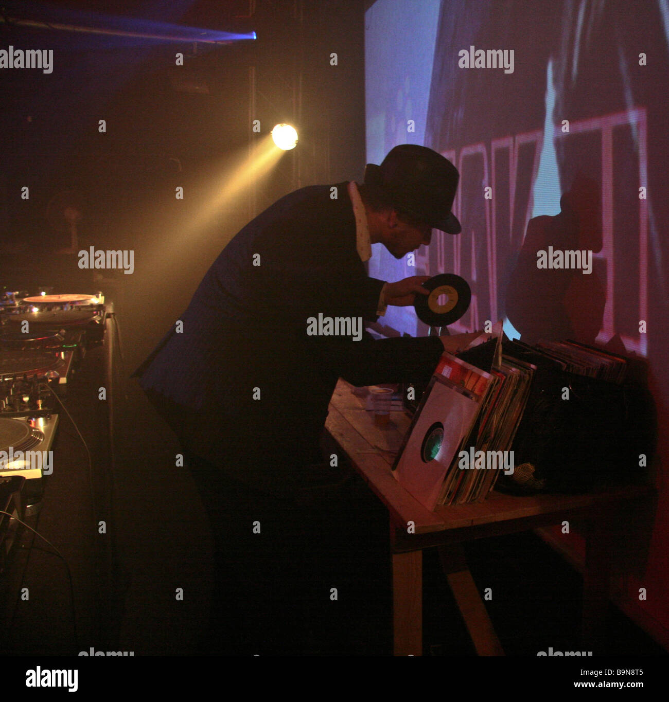A DJ choosing records whilst playing a set Stock Photo - Alamy