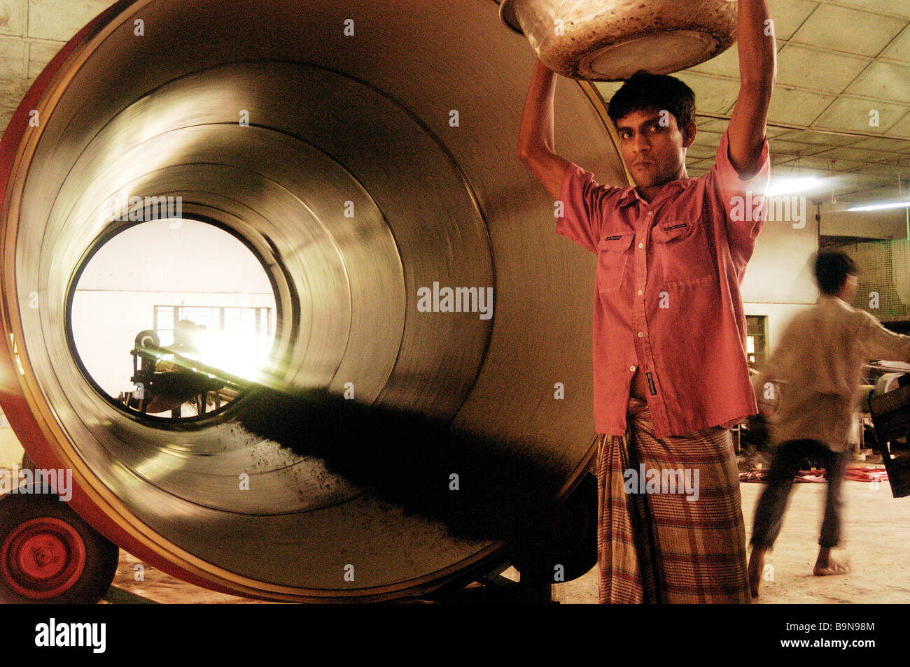 Boy working tea processing factory Stock Photo - Alamy