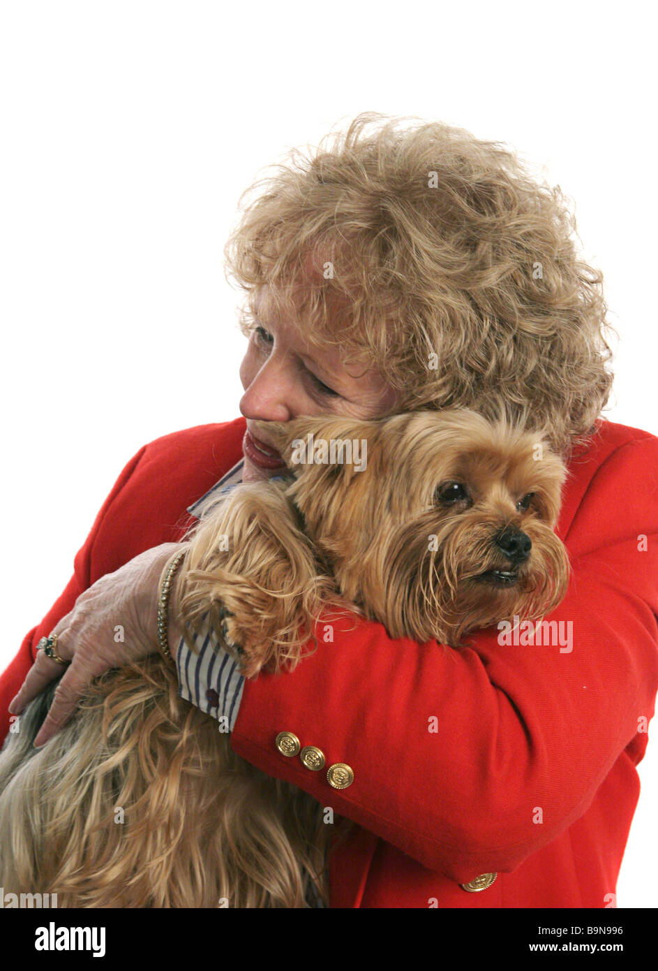 A woman giving her pet yorkie dog a big hug Focus is on dog s face ...