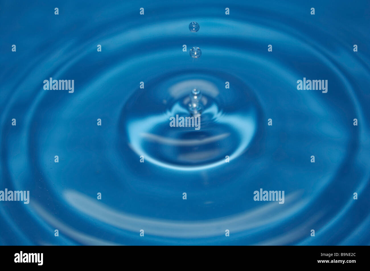 a drip in blue water Stock Photo - Alamy
