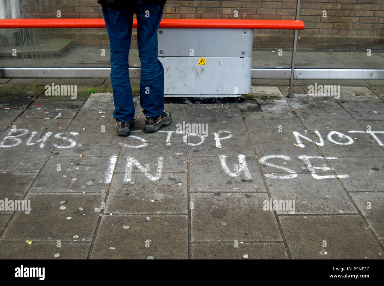 bus stop not in use notice written on the ground at a bus stop in ...