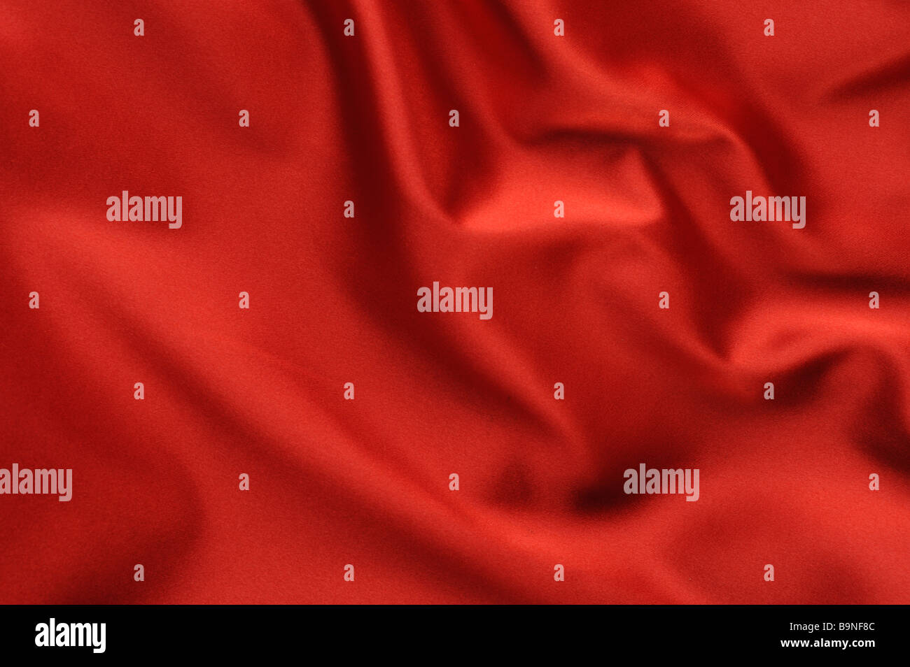 red satin background A satiny fabric with beautiful light shadow waves ...