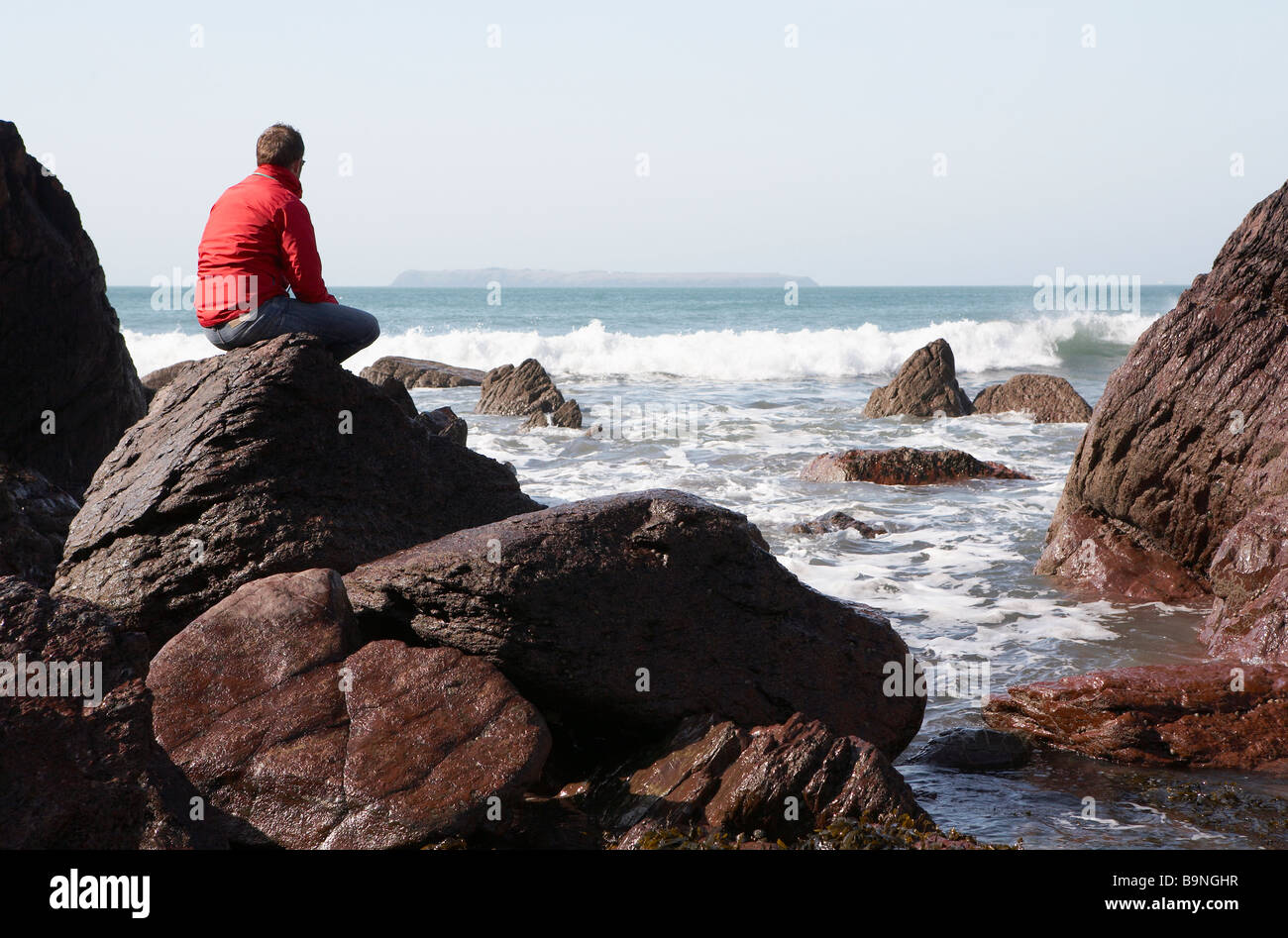 Rear man sitting rock coast hi-res stock photography and images - Alamy