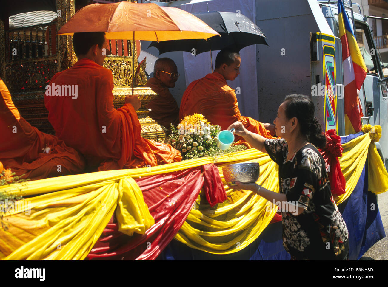 A woman anoints the float carrying one of Laos' most venerated Buddha ...