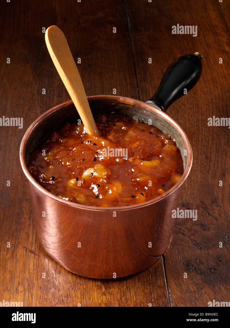 A copper saucepan of mango chutney Stock Photo - Alamy