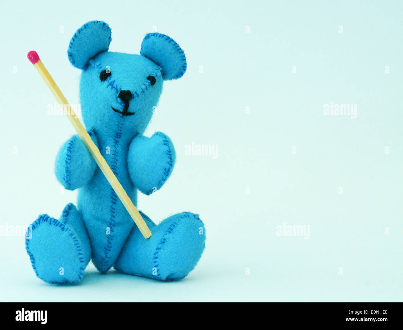 Miniature teddy playing with a match stick (Mini Bear Collection Stock ...
