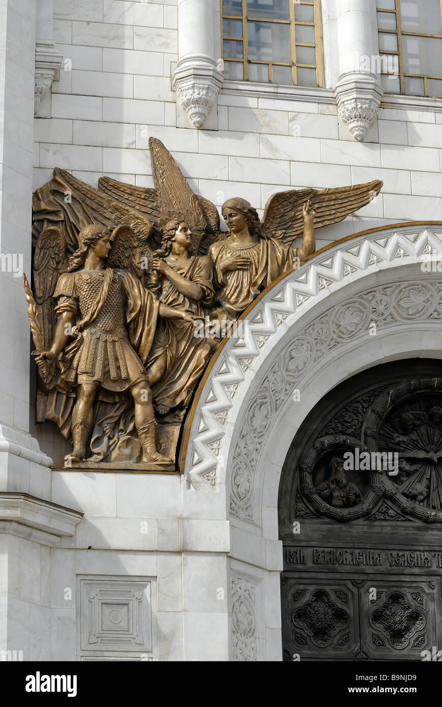 Three bronze angels above an entrance in the cathedral of Christ the ...